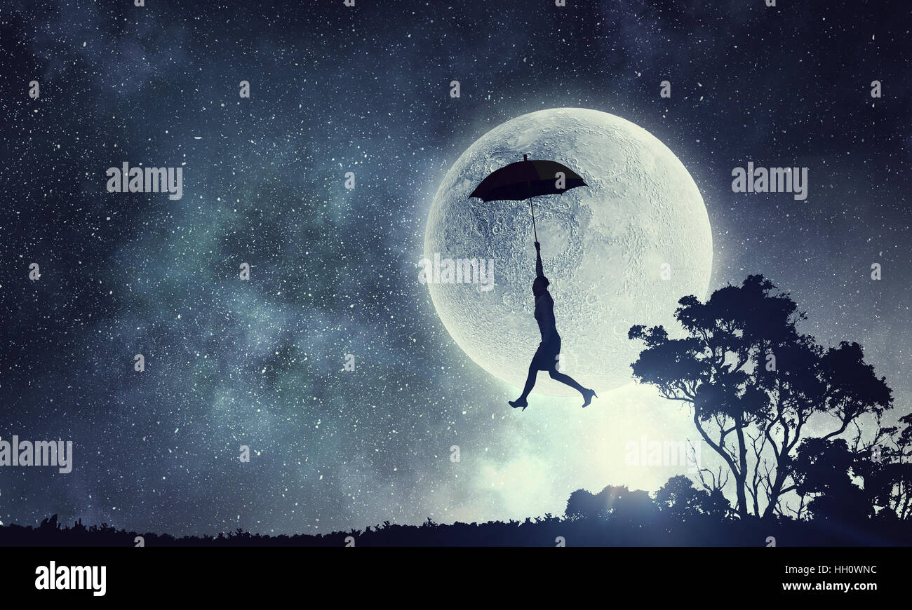 Young businesswoman flying in night sky with full moon Stock Photo - Alamy