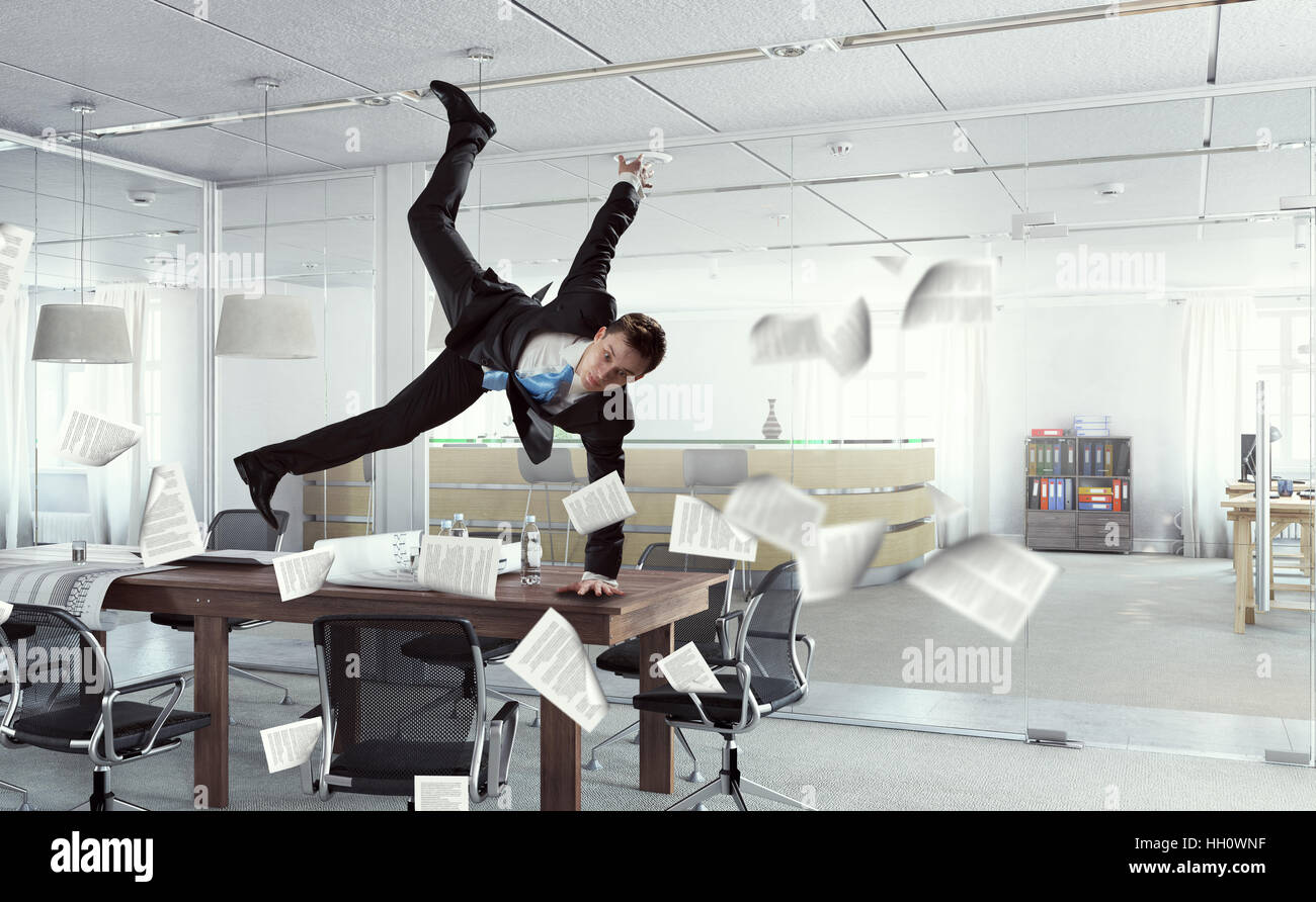 Young cheerful businessman dancing in his office. Mixed media Stock ...