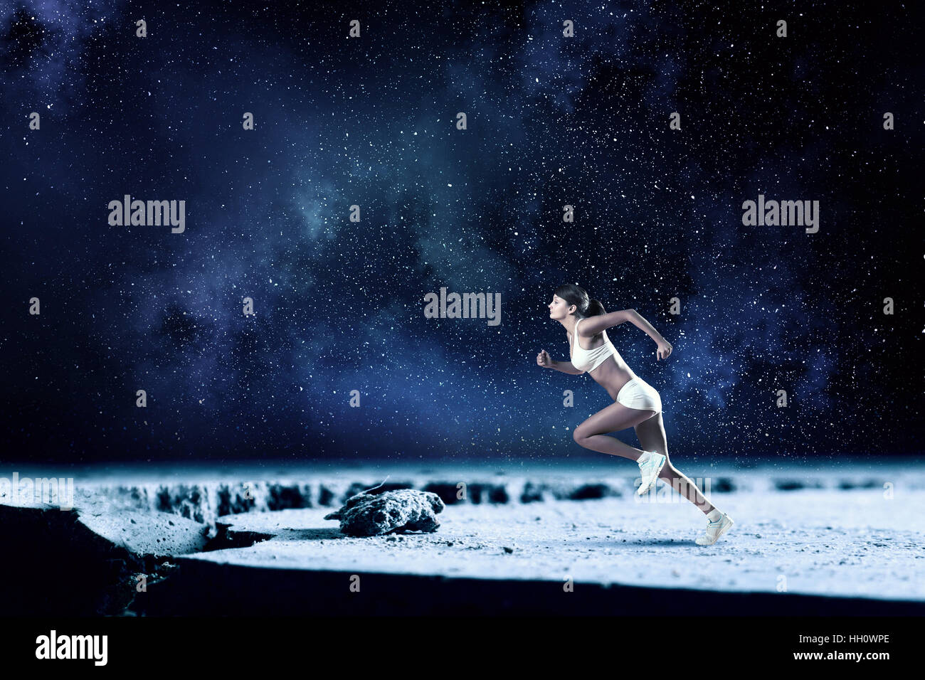 Young woman athlete running fast on dark background Stock Photo - Alamy
