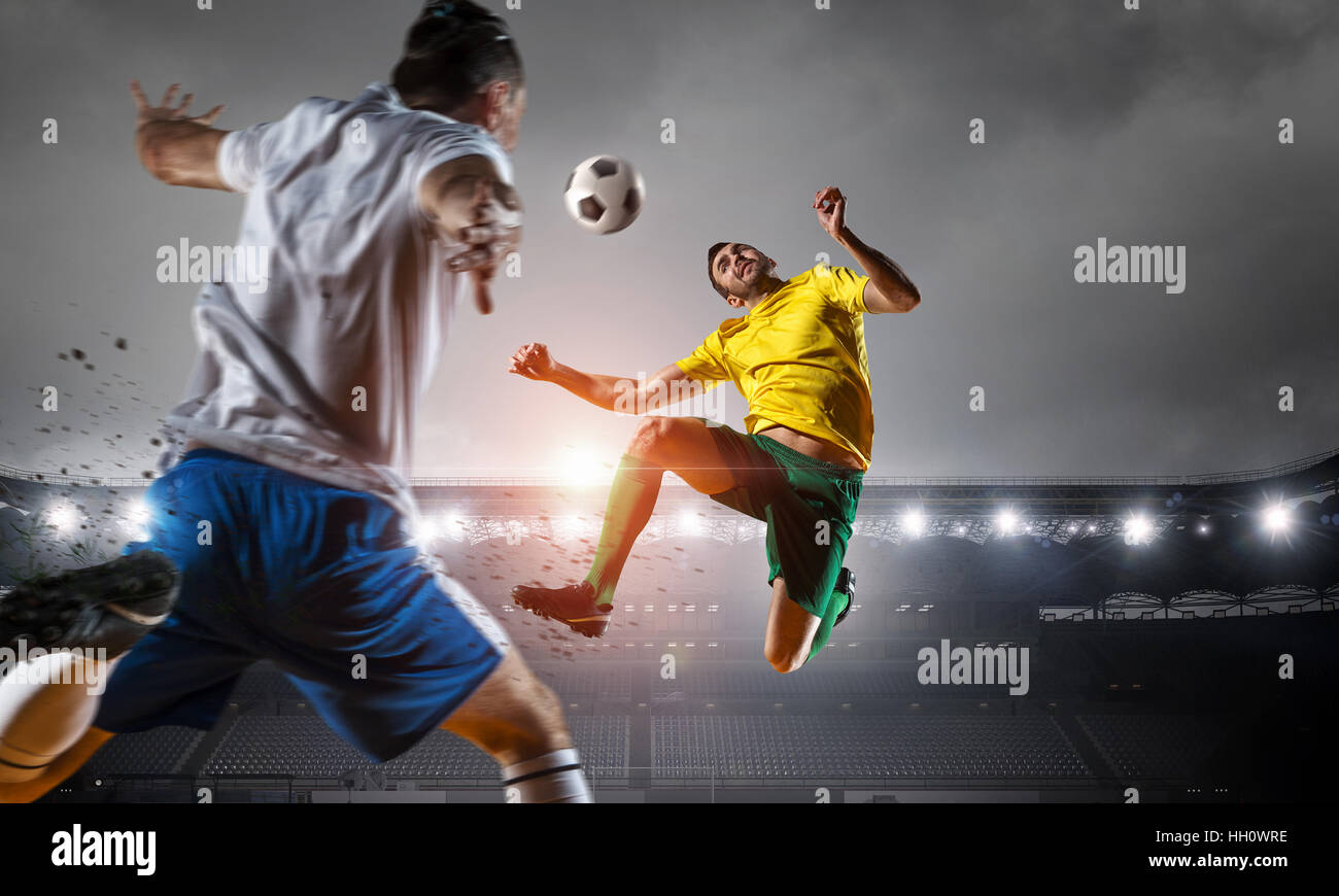 Soccer players in action on stadium fighting for ball. Mixed media ...