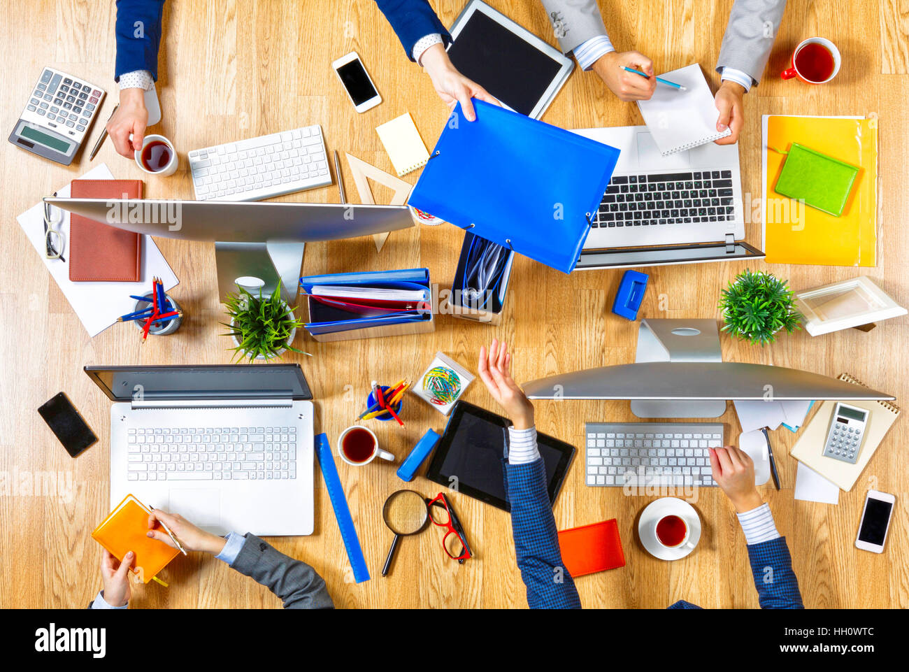 Top view of office table with four colleagues working together Stock ...