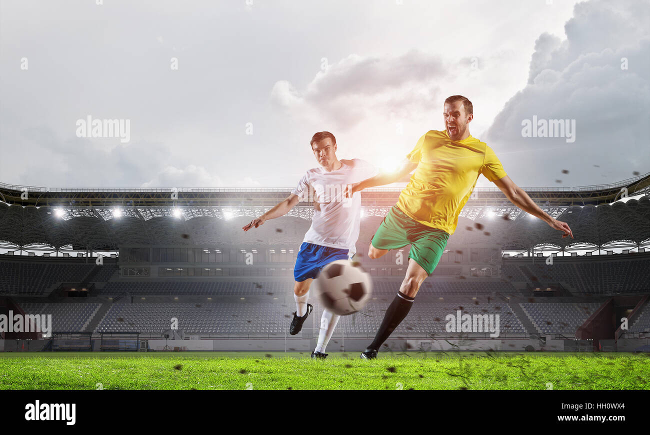 Soccer players in action on stadium fighting for ball. Mixed media ...