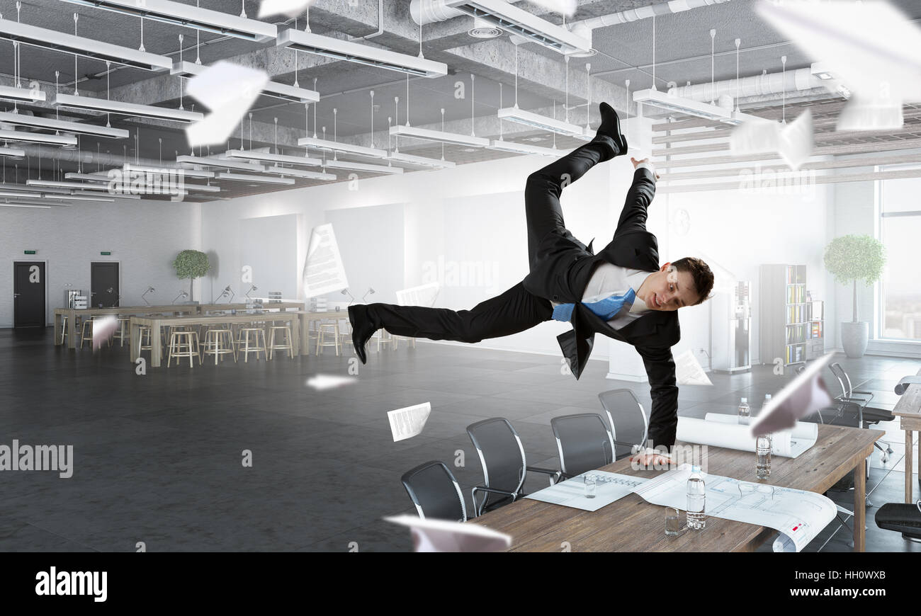 Young cheerful businessman dancing in his office. Mixed media Stock ...