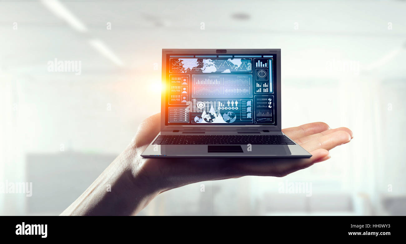 Close of hand holding laptop in palm. Mixed media Stock Photo - Alamy