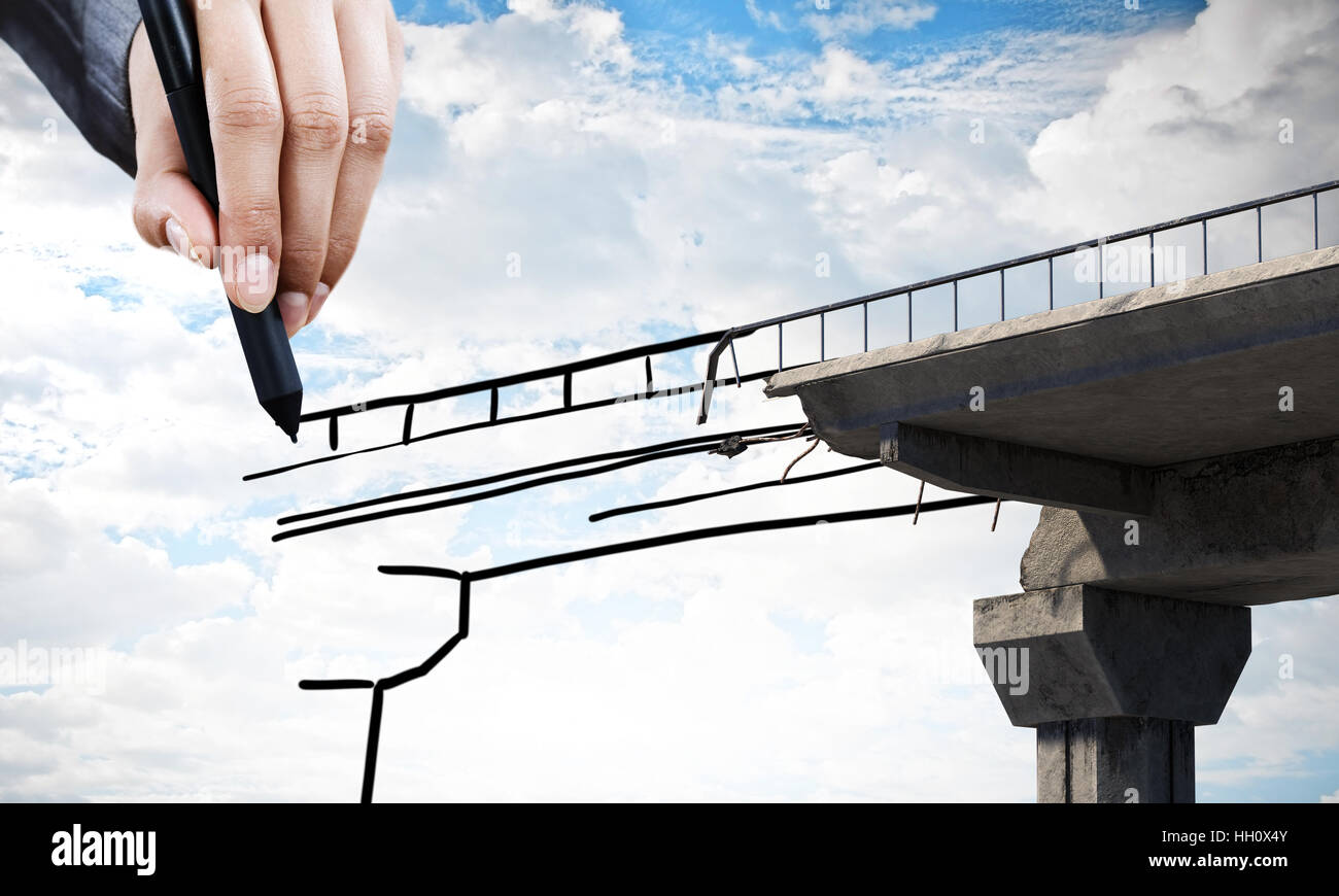Hand of female drawing elements of crashed bridge Stock Photo - Alamy