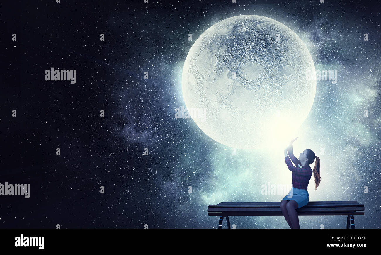 Silhouette of woman against starry sky catching moon Stock Photo - Alamy