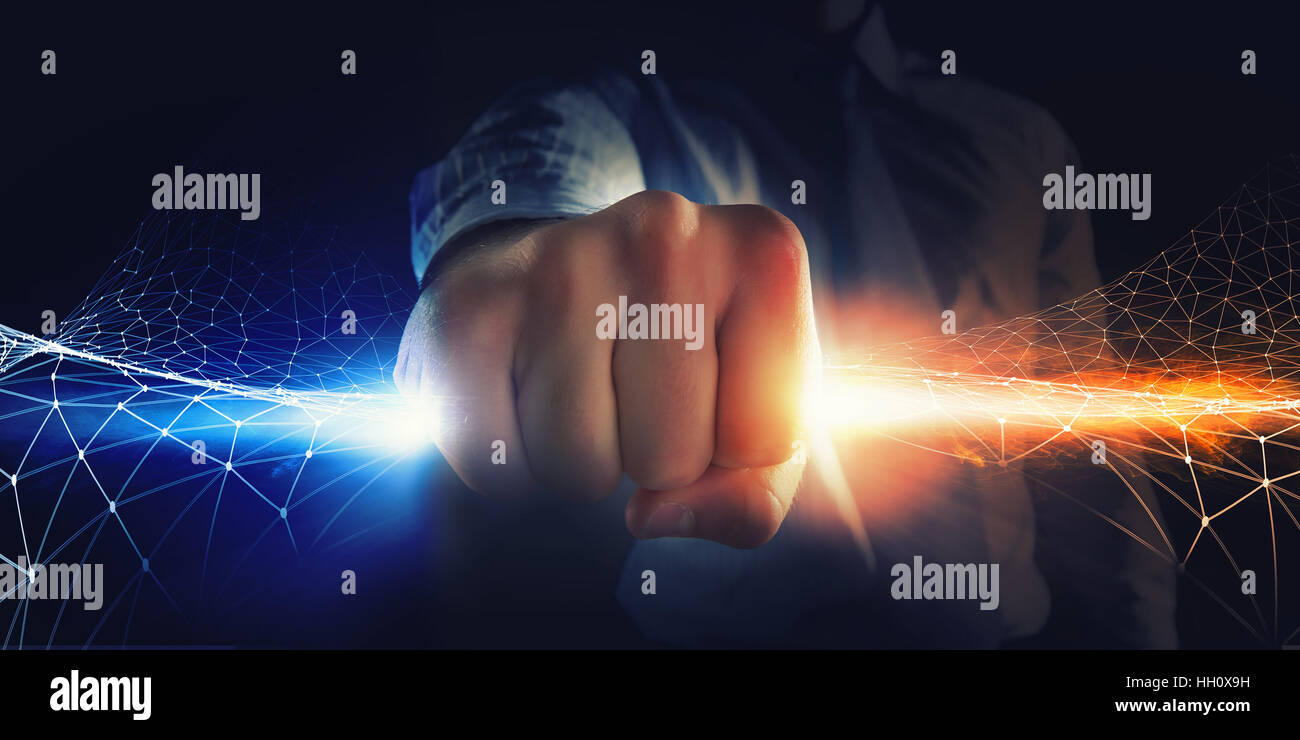 Hand of businessman holding in fist glowing light Stock Photo - Alamy