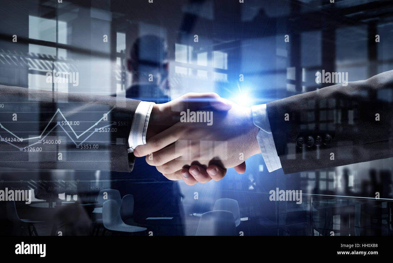 Close up of business handshake against office interior background ...
