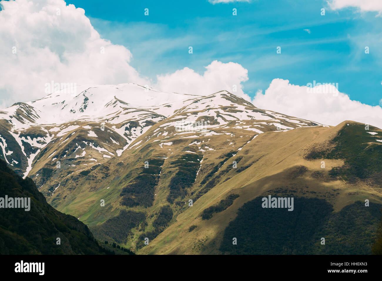 Clouds Fly Low Over Rocks. Mountain Peaks Covered With Snow. Varied ...