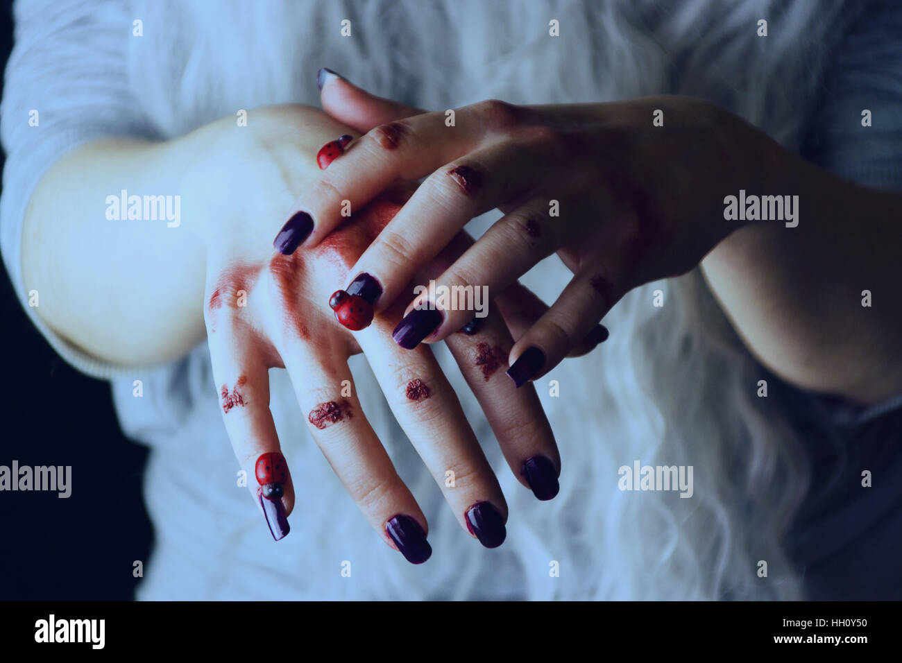 Young woman's hand with blood and ladybugs Stock Photo - Alamy