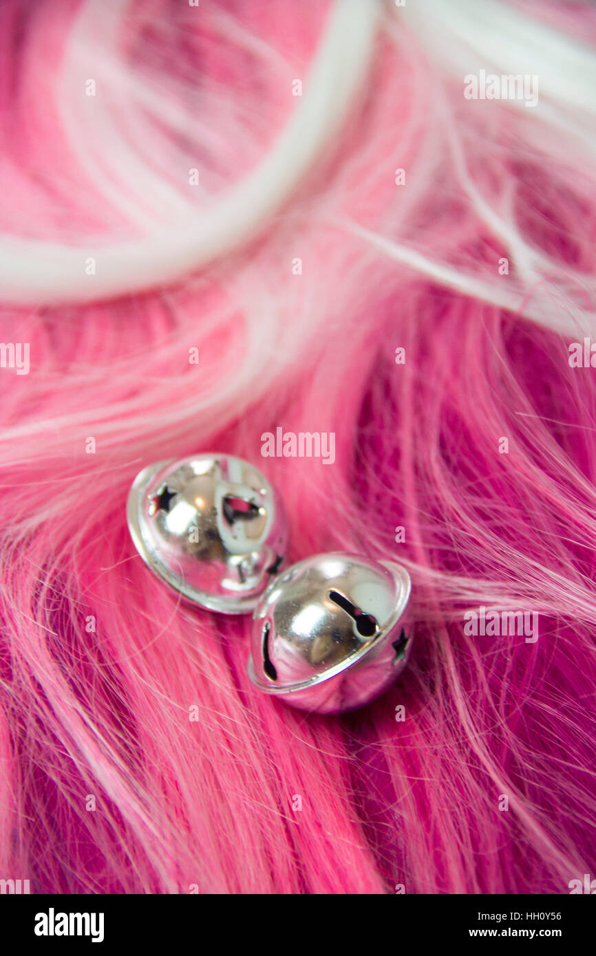 Pink and white hair with two silver tinker bells Stock Photo - Alamy