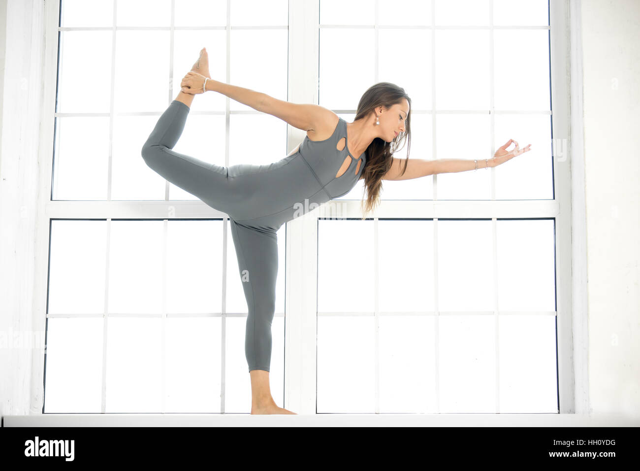 Young attractive woman in Natarajasana pose, window background Stock ...