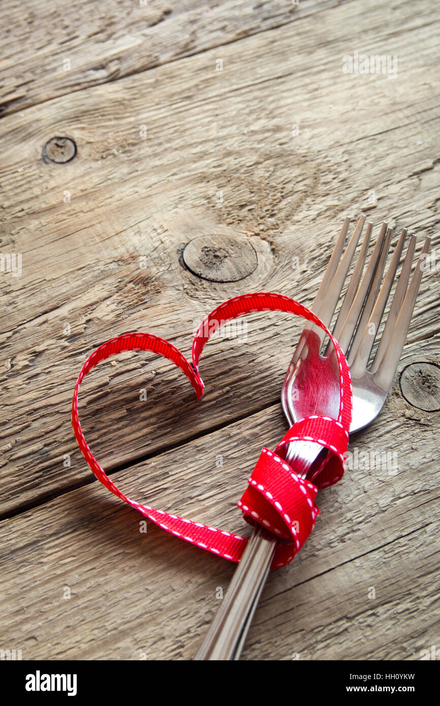 Table setting (two forks) for Valentine's Day with red hearts on rustic ...