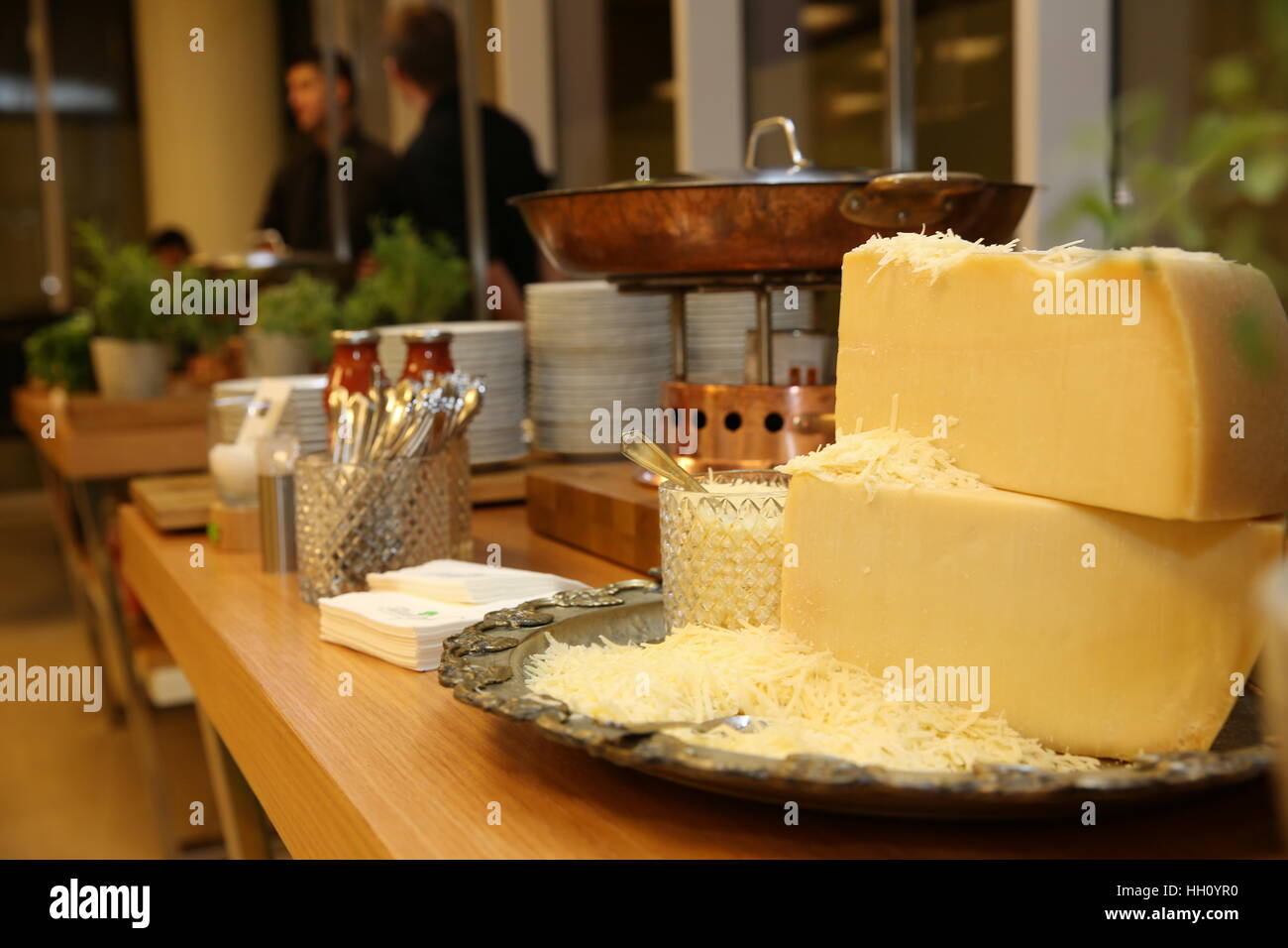 Yellow cheese wheels and gratings Stock Photo - Alamy
