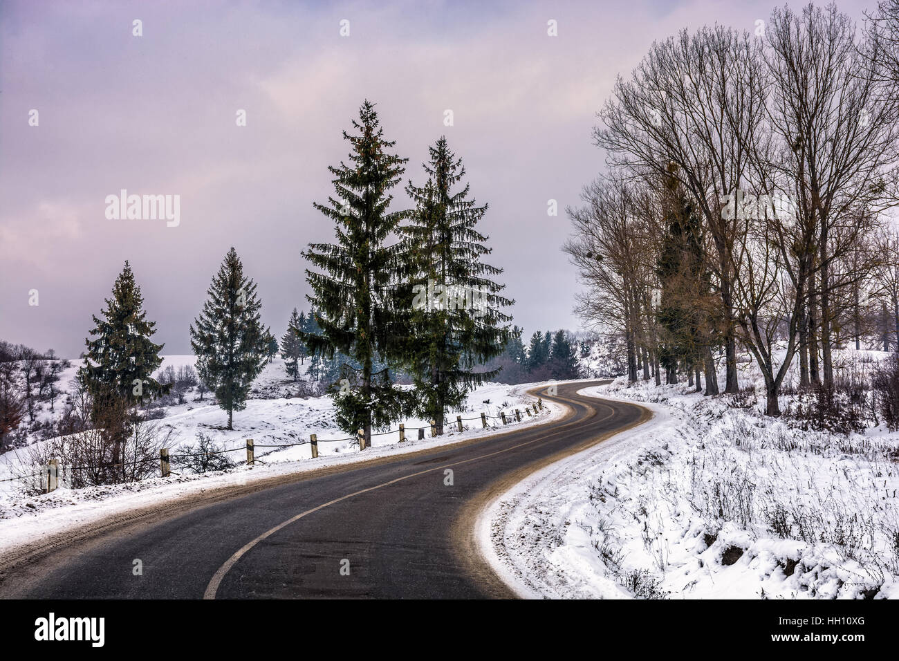 empty winding mountain road on a hillside in the early morning Stock ...
