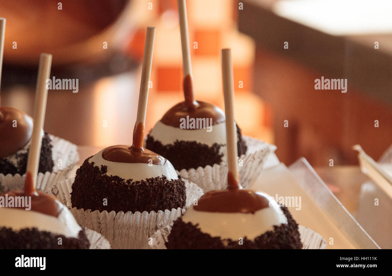 Candy apples with caramel and nuts on a stick in a candy store window ...