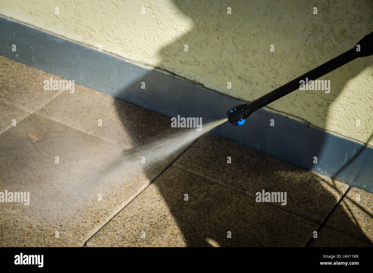 cleaning a terrace with hight pressure water washer Stock Photo - Alamy