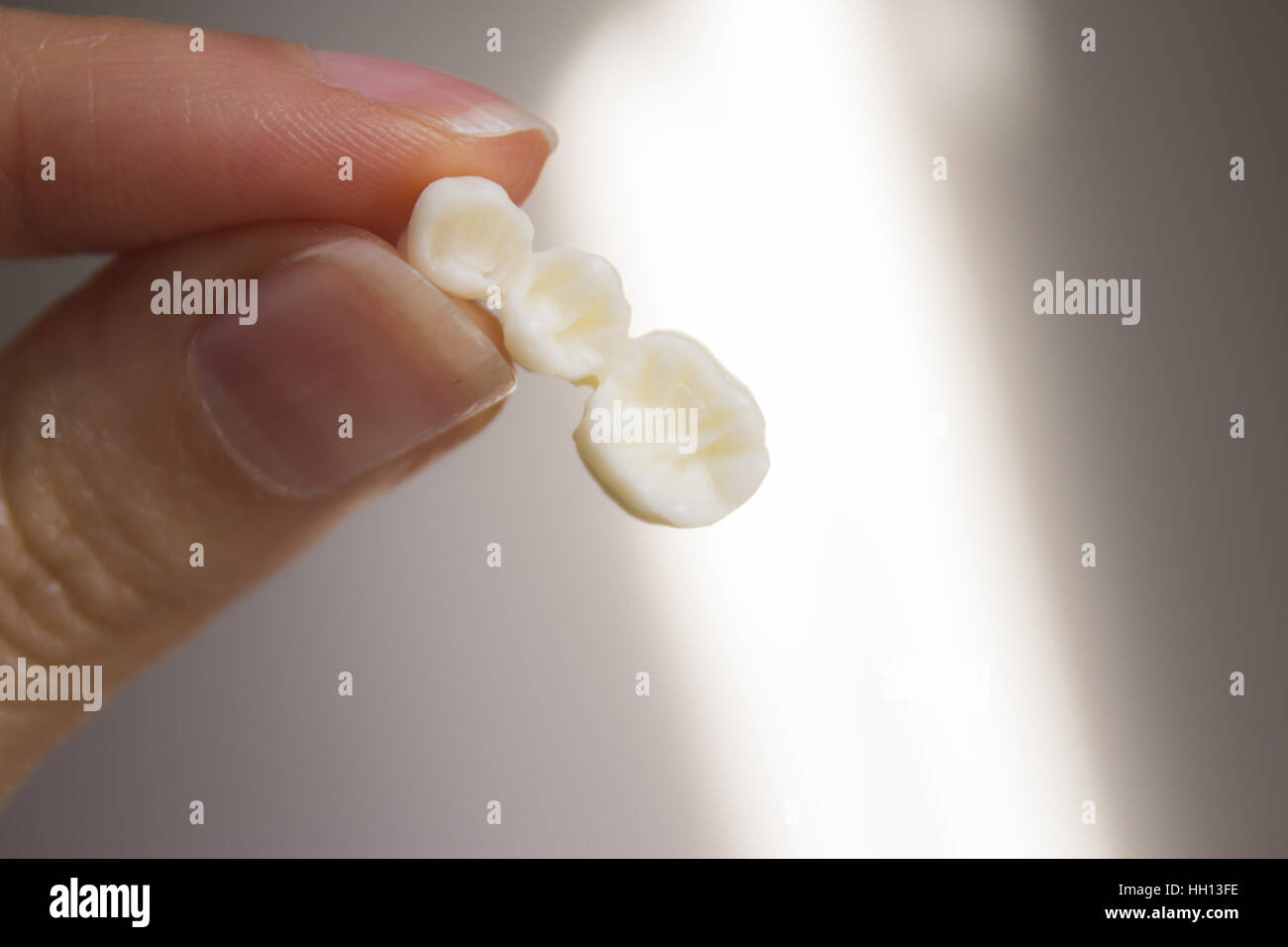 Woman holding false teeth hi-res stock photography and images - Alamy