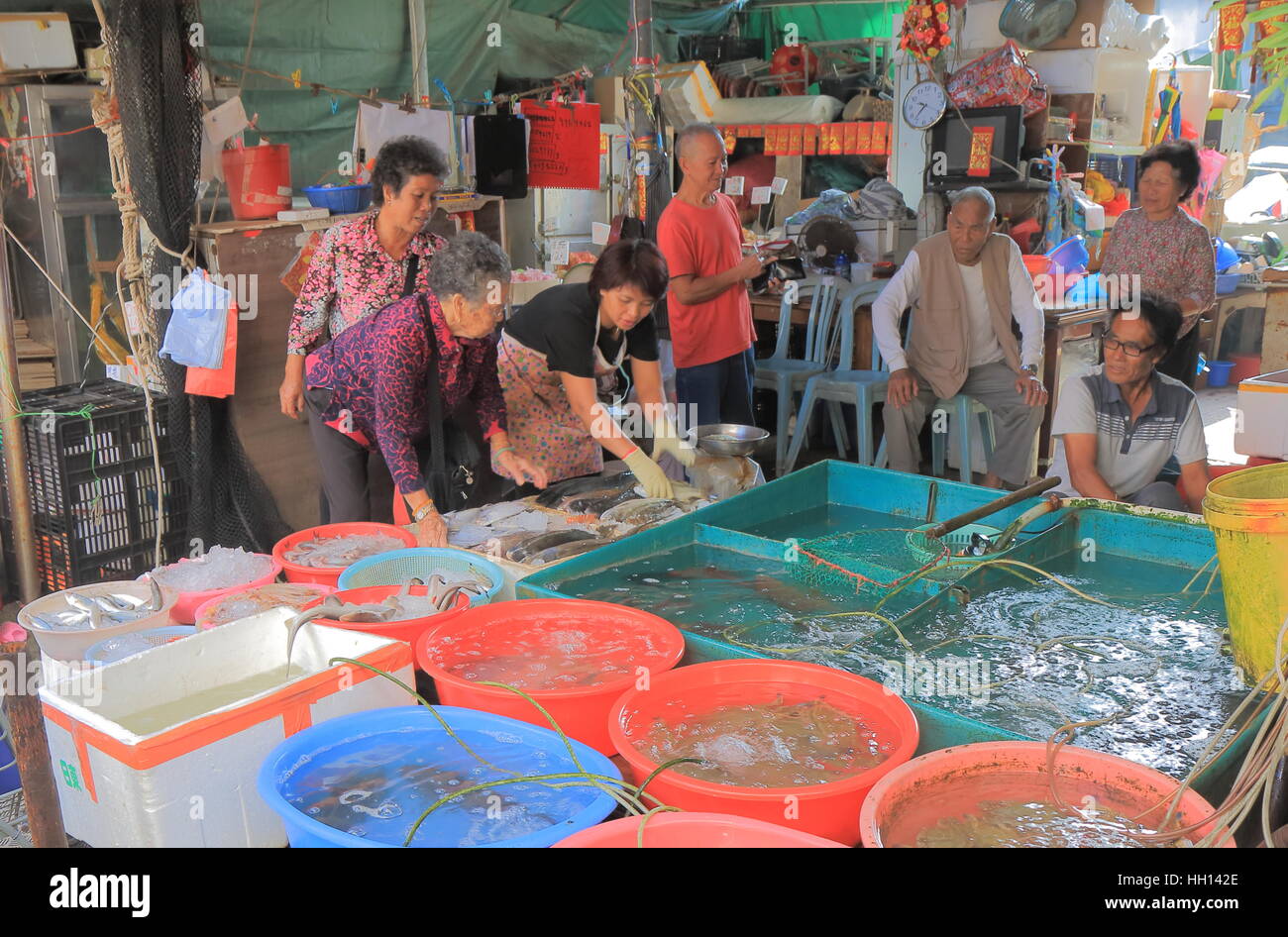 People sell fish at Tai O village market Lantau island in Hong Kong ...