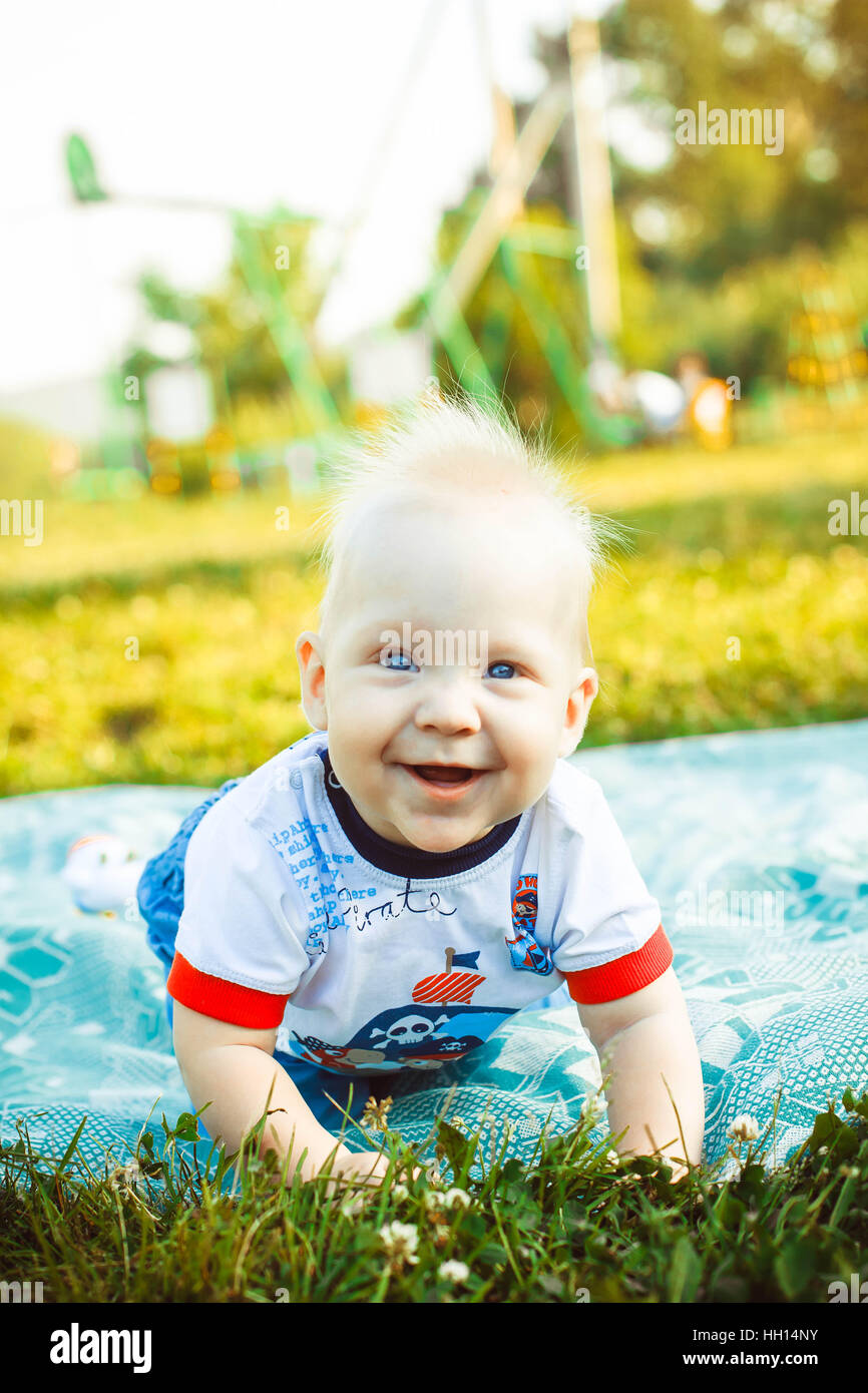 baby smiling and crawling on lawn Stock Photo - Alamy