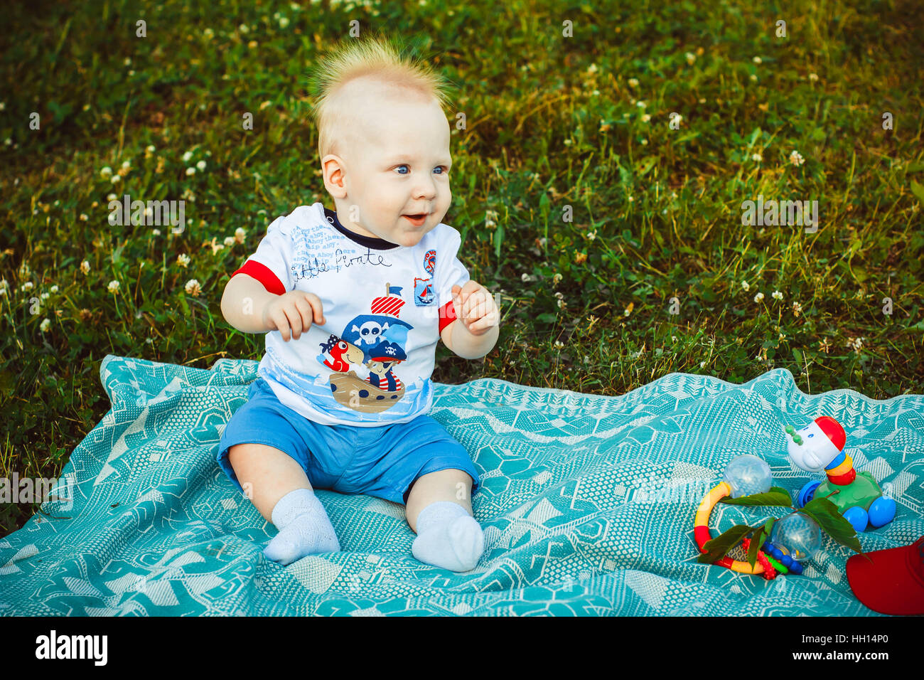 baby smiling and crawling on lawn Stock Photo - Alamy