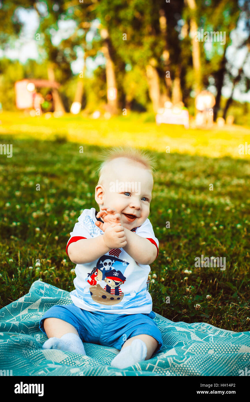 baby smiling and crawling on lawn Stock Photo - Alamy