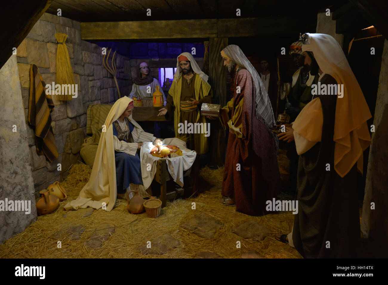 Nativity scene with giant puppets in a barn Stock Photo - Alamy