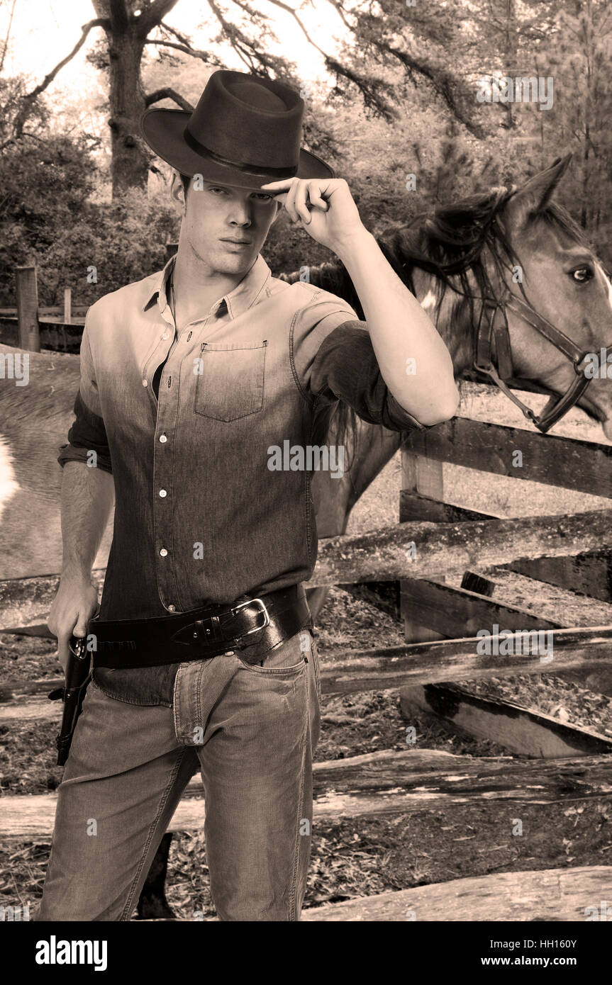 Handsome cowboy man with six shooter guns Stock Photo - Alamy