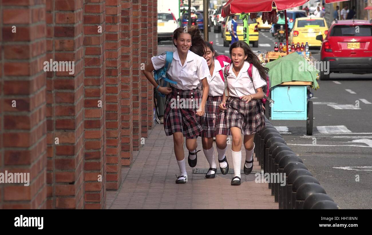 Female Students Running On Sidewalk Stock Photo - Alamy