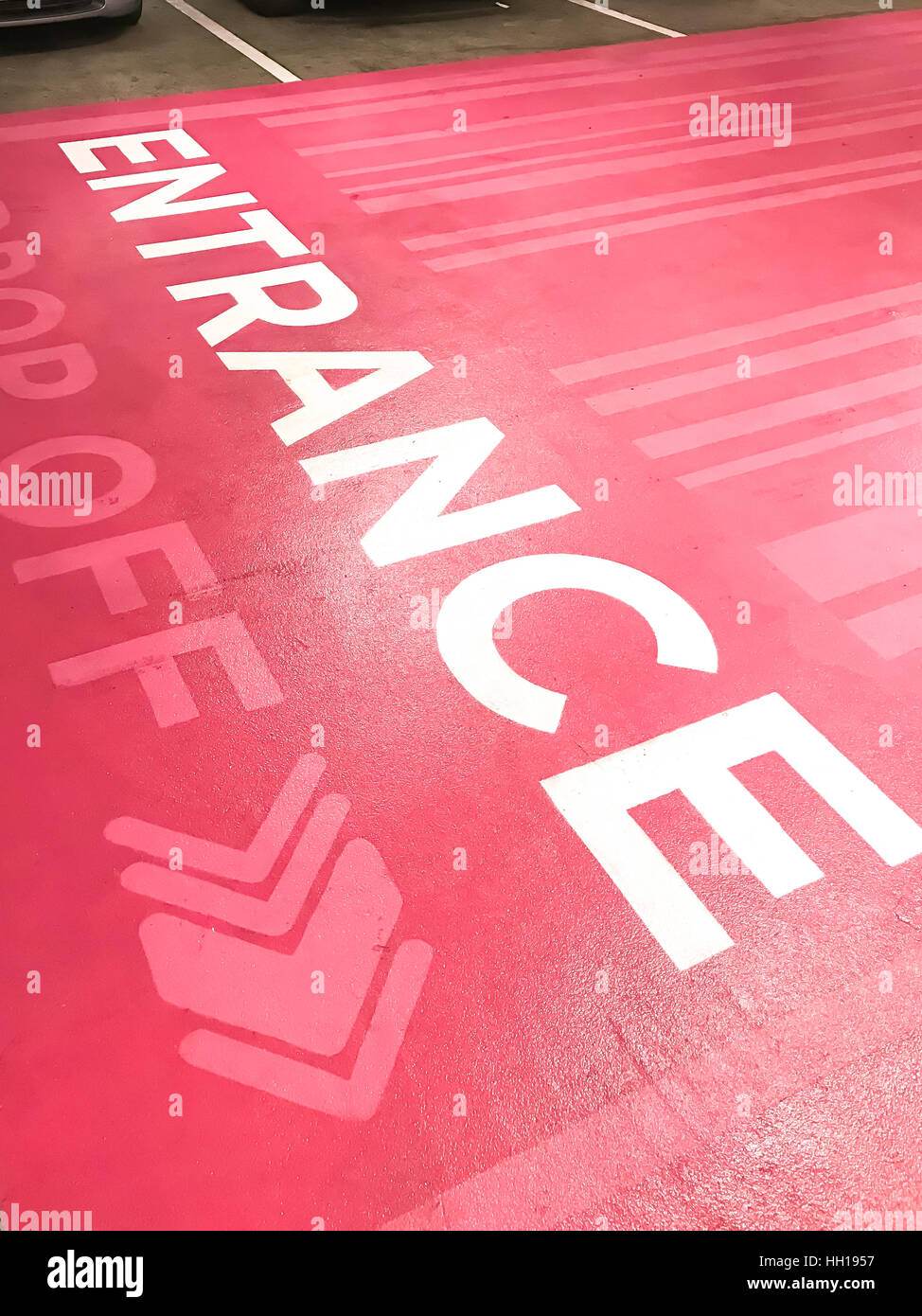 Entrance text and drop off sign on pink floor Stock Photo - Alamy