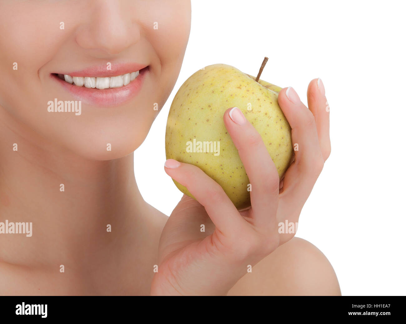 Smiling beauty woman holding green apple while isolated on white Stock ...