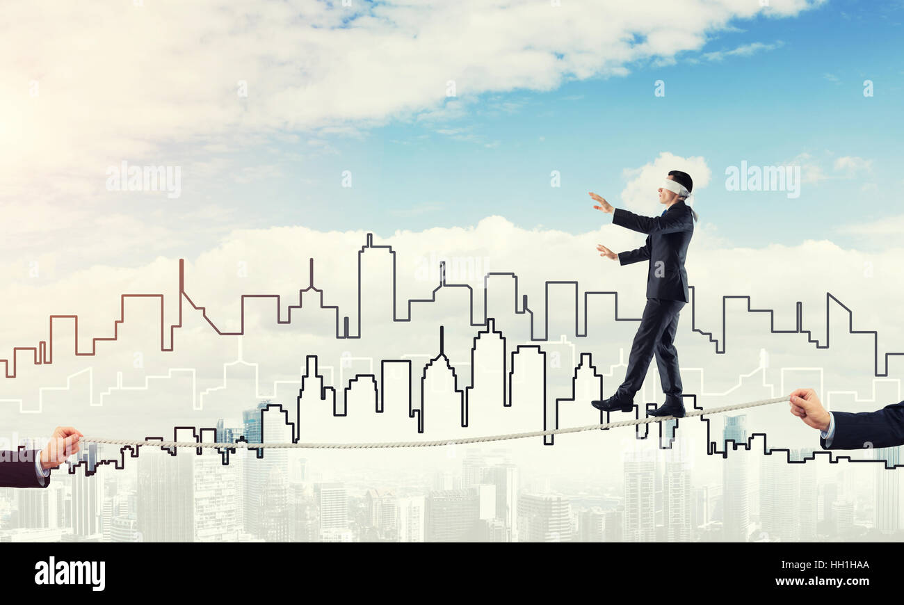 Business concept of risk support and assistance with man balancing on ...
