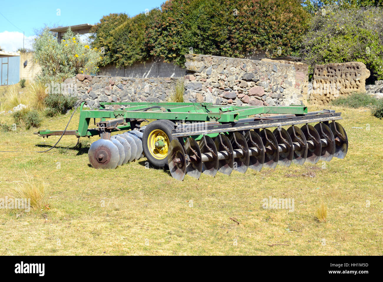 Disc harrow farm equipment in field in rural village Stock Photo - Alamy