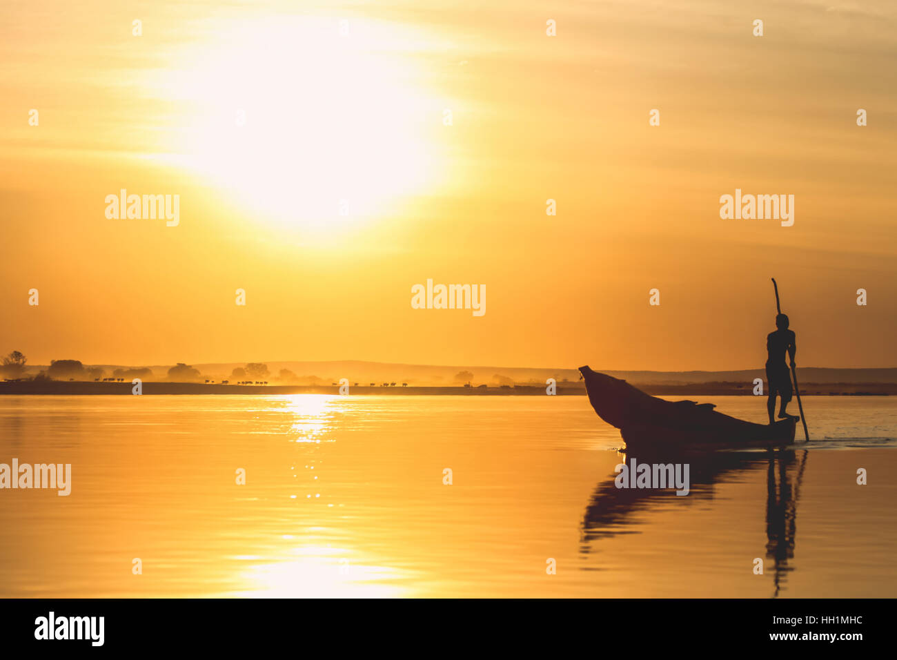 Traditional fishing pirogue at sunset on the Tsiribihina river in ...