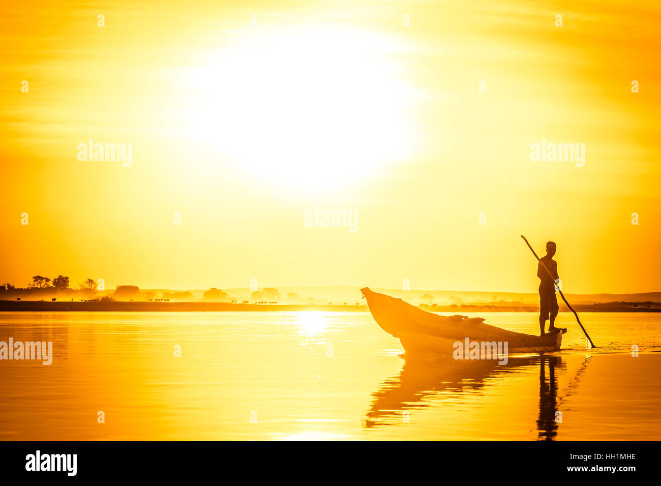Traditional fishing pirogue at sunset on the Tsiribihina river in ...