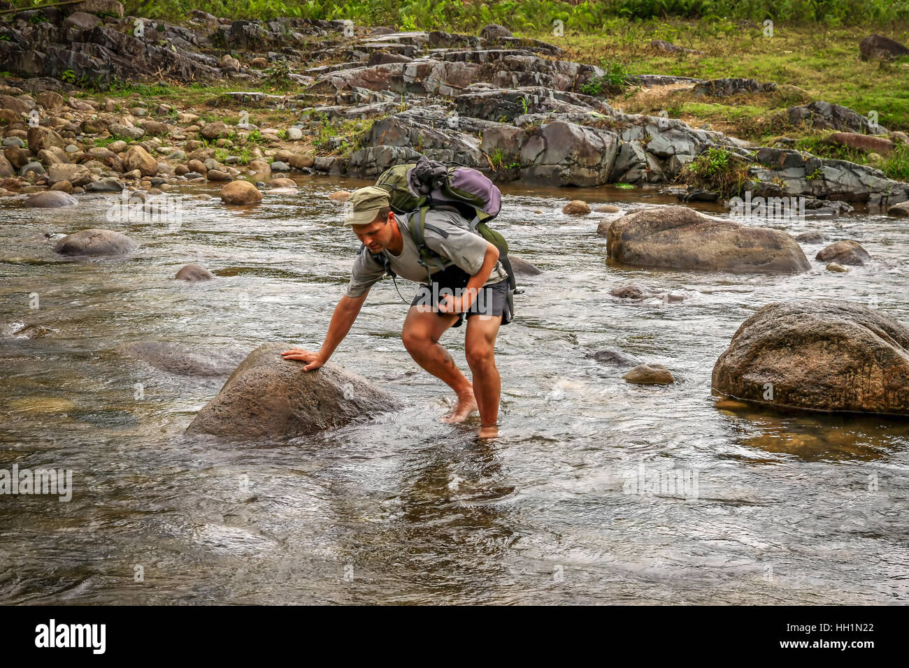 Man crossing the river in the Madagascar jungle Stock Photo - Alamy