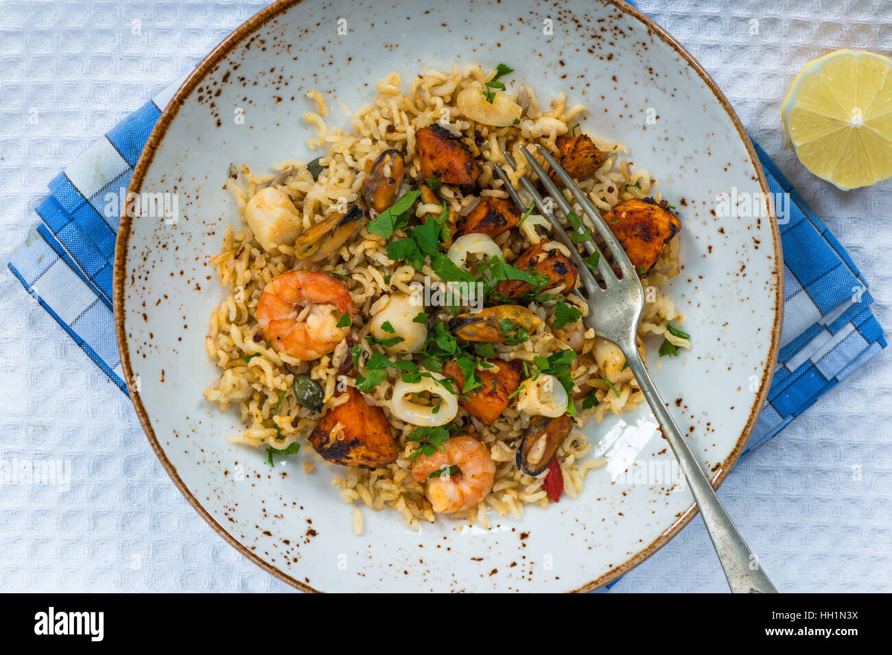 Seafood pilaf or risotto on a plate - top view Stock Photo - Alamy