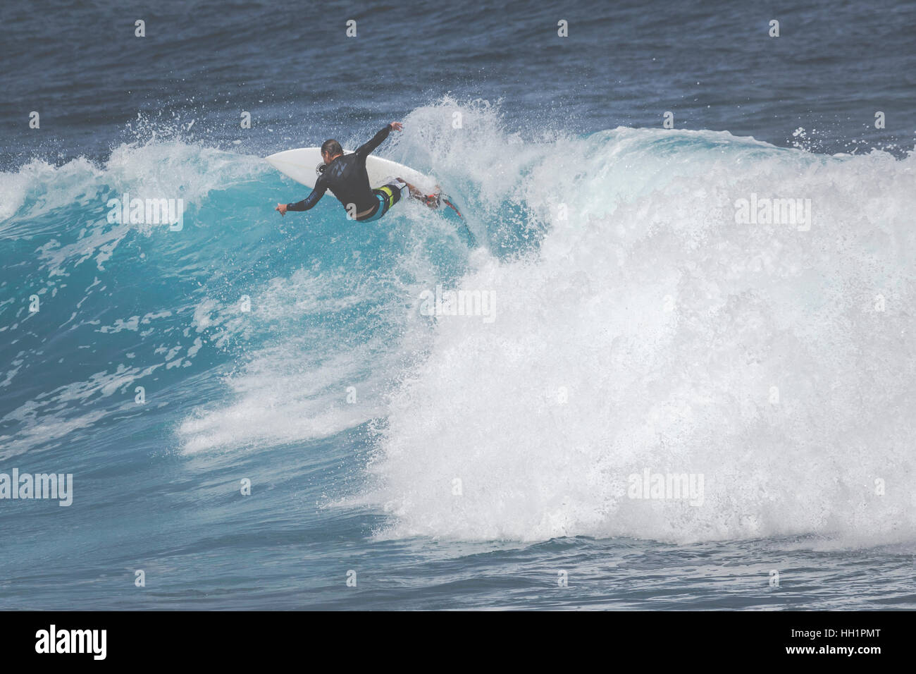 MAUI, HI - MARCH 10, 2015: Professional surfer rides a giant wave at ...