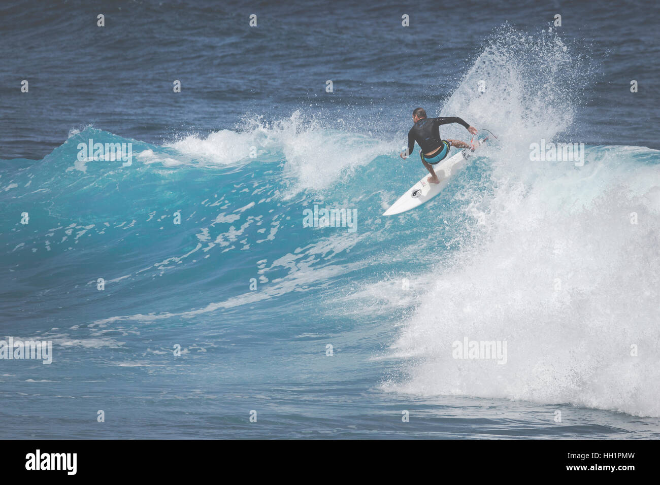 MAUI, HI - MARCH 10, 2015: Professional surfer rides a giant wave at ...