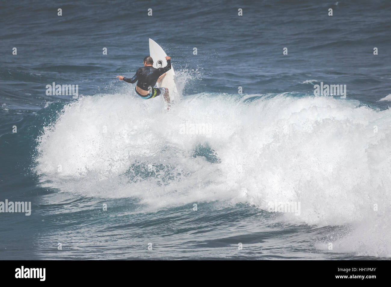 MAUI, HI - MARCH 10, 2015: Professional surfer rides a giant wave at ...