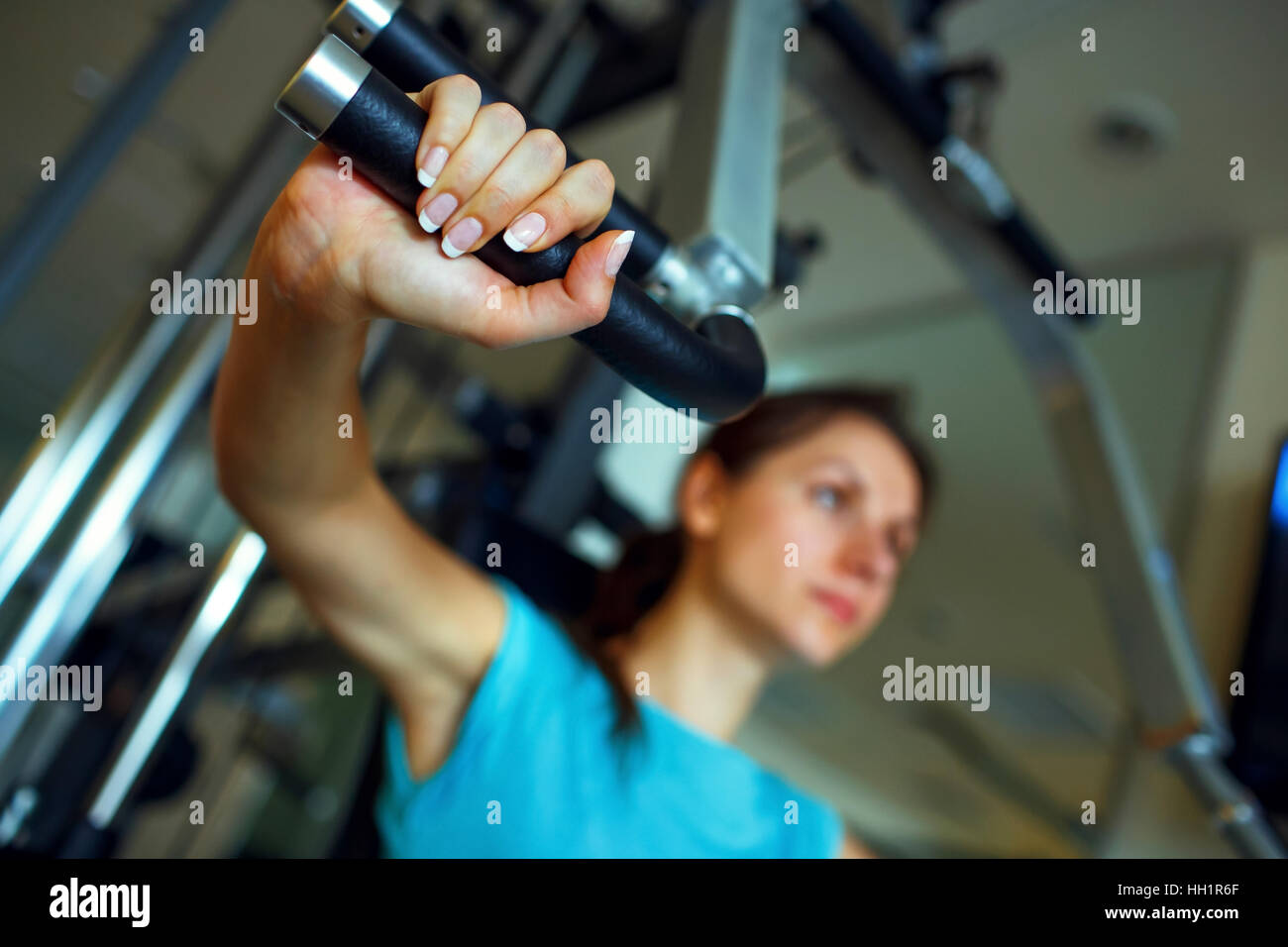 Athletic woman works out on training apparatus in fitness center Stock ...