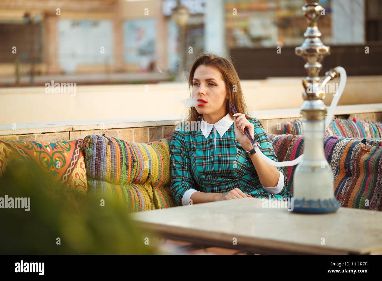 Beautiful young woman smokes a hookah in a cafe, Egypt Stock Photo - Alamy