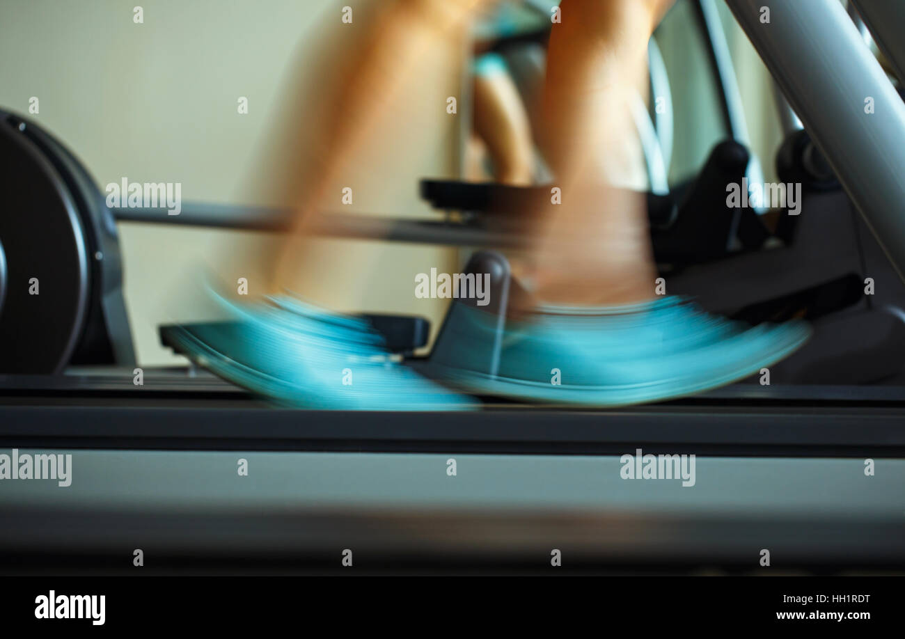 Foot of woman running on treadmill in gym Stock Photo - Alamy