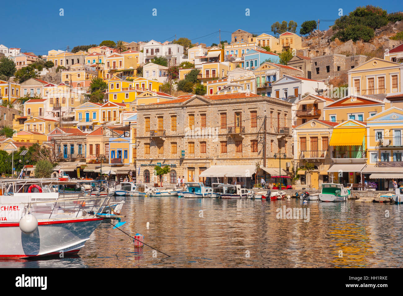 The buildings alongside the harbour on Symi Greece Stock Photo - Alamy