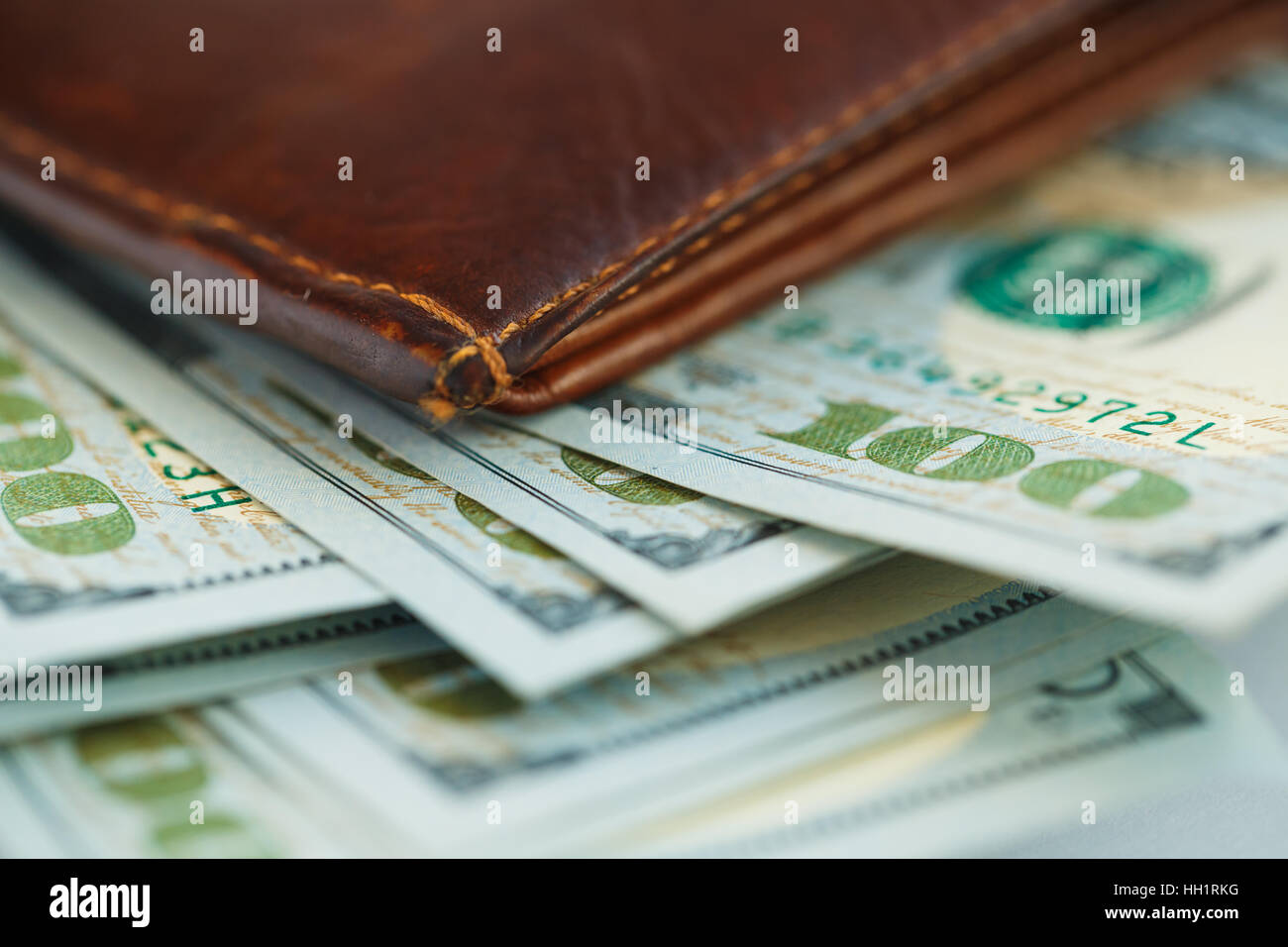 Brown leather wallet with USA dollars money inside it Stock Photo - Alamy