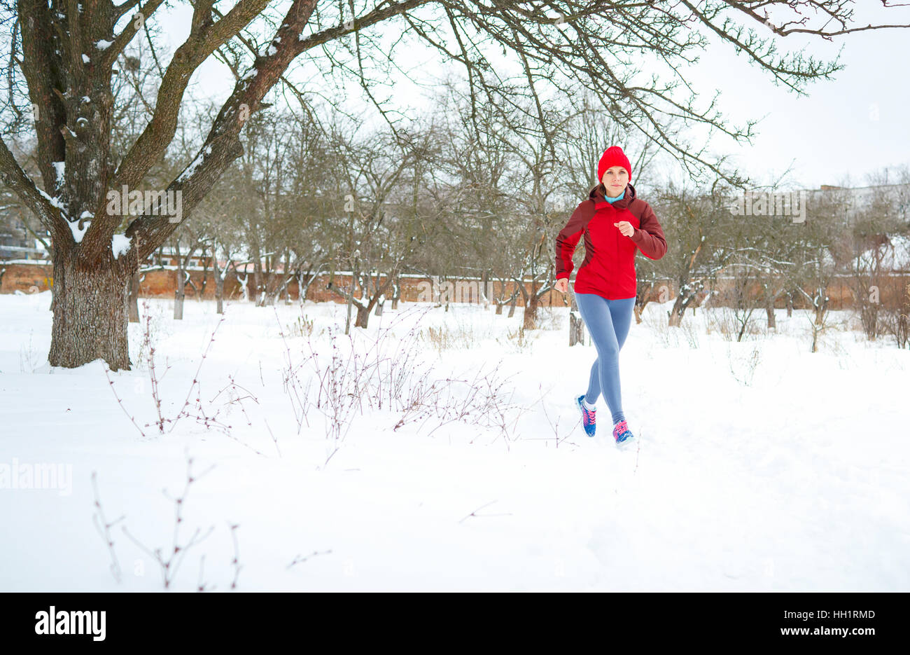 Sport woman running in winter. Female runner portrait in full body ...