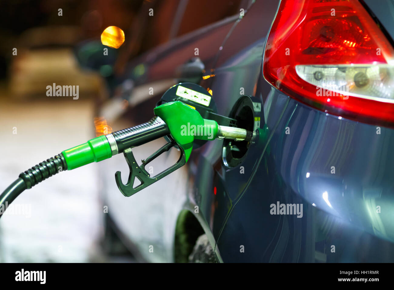 Car refueling on a petrol station in winter at night closeup Stock ...