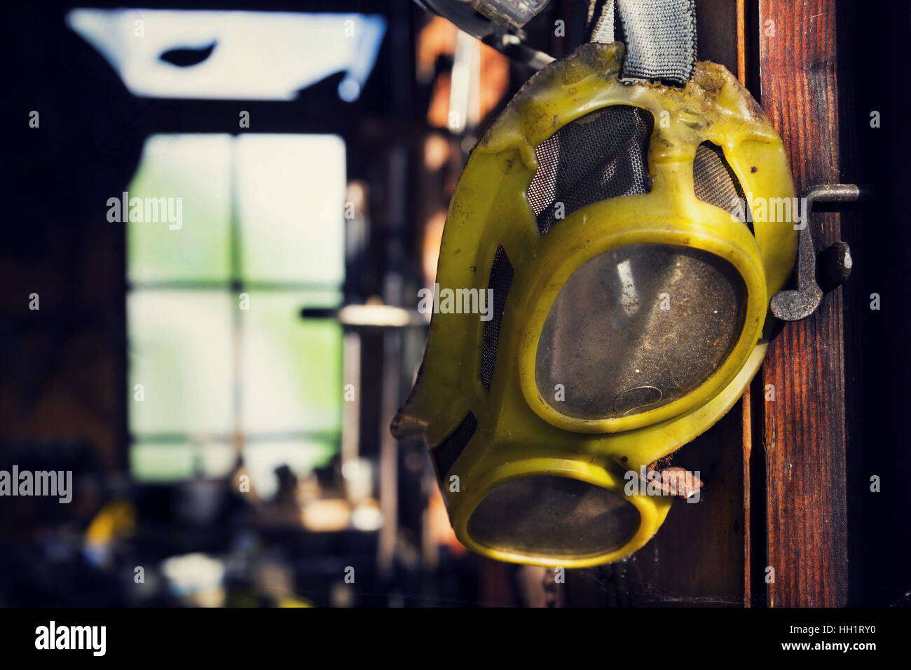 Filtered yellow vintage safety glasses hanging in wooden workshop Stock ...