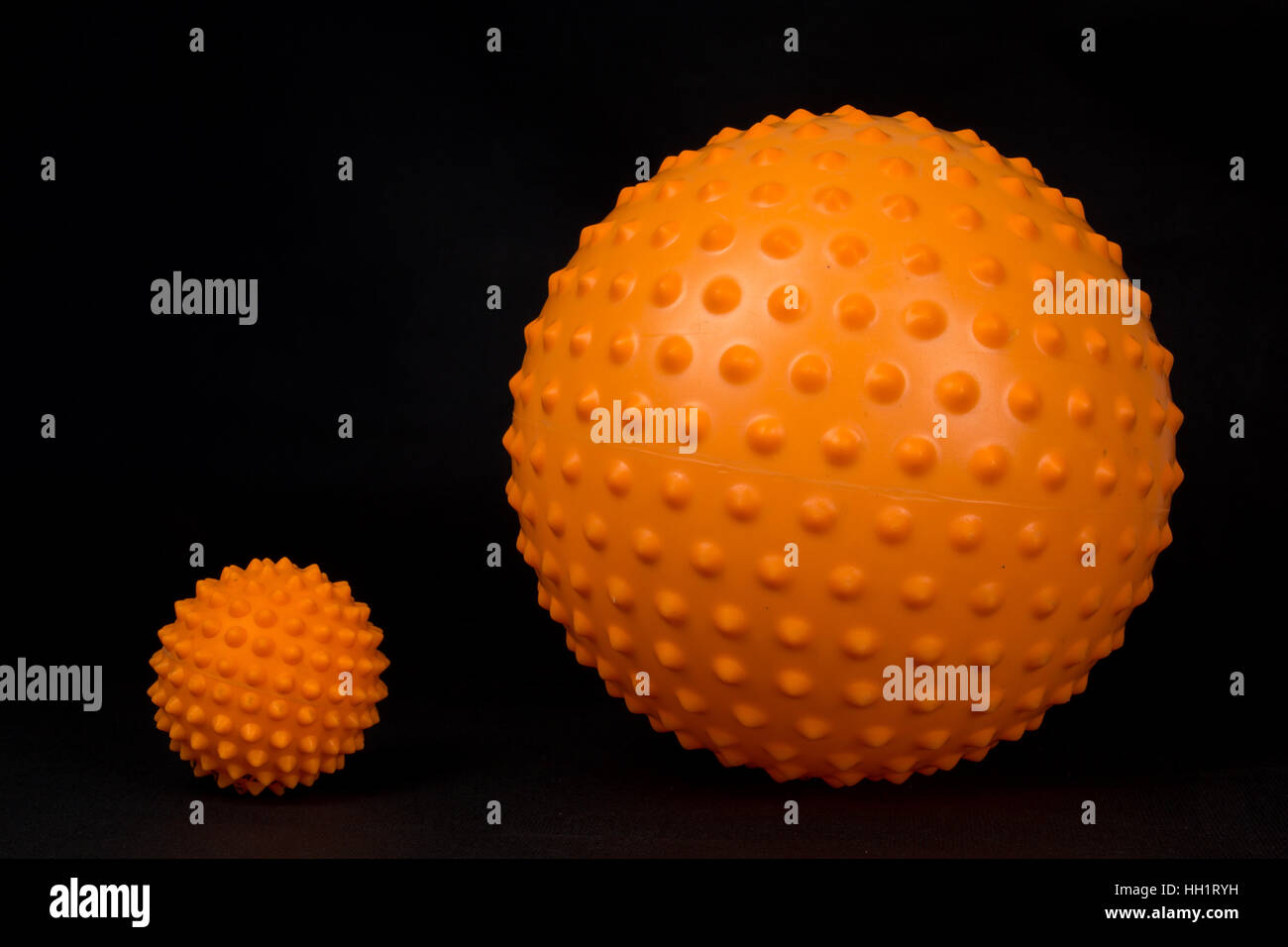 Two spiky massage balls on black background Stock Photo - Alamy