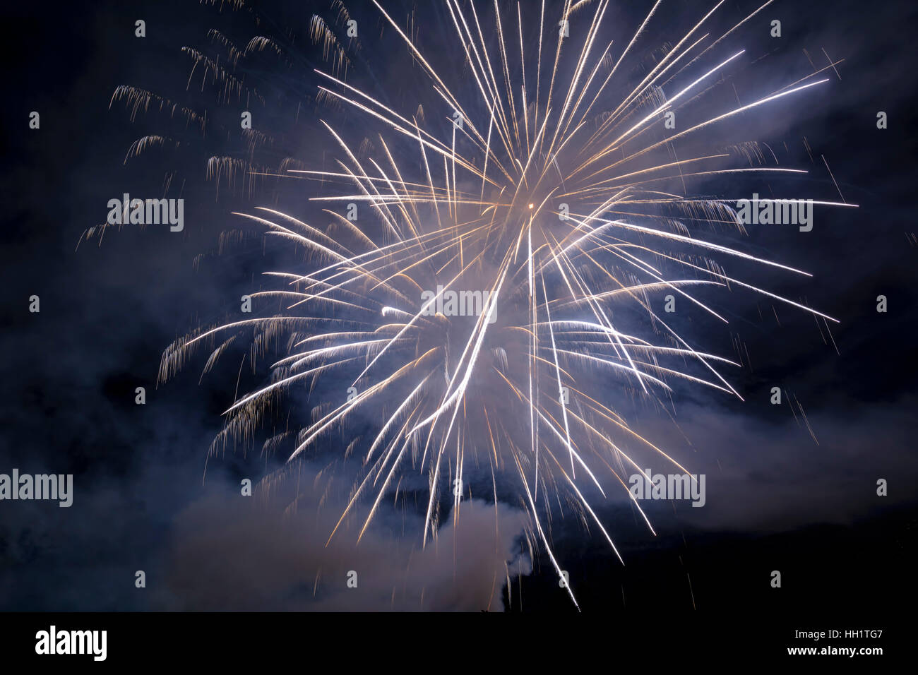 Explosion of fireworks in the smoke in the night Stock Photo - Alamy